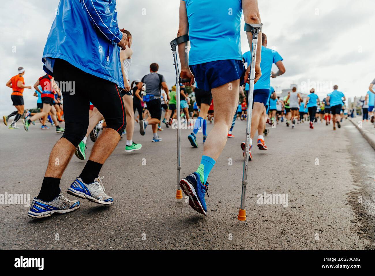 one-legged athlete on crutches running city marathon Stock Photo - Alamy
