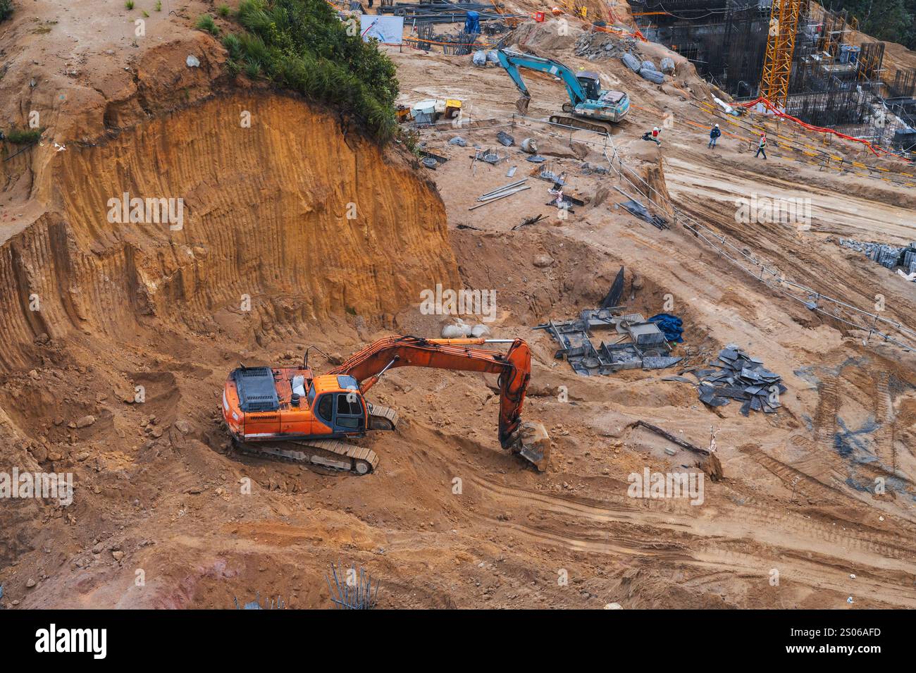 Excavator dig the ground in the foundation pit of building on a ...