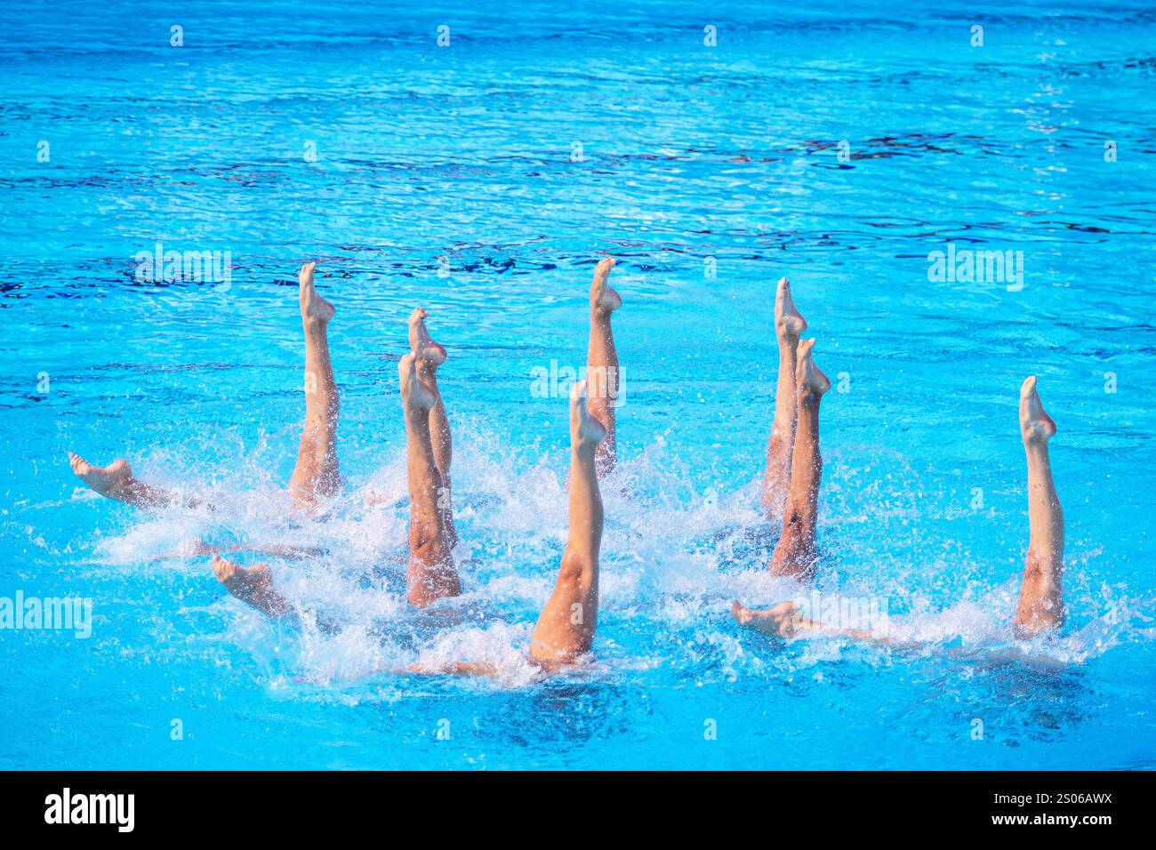 Artistic swimmers team performing synchronized legs choreographed ...