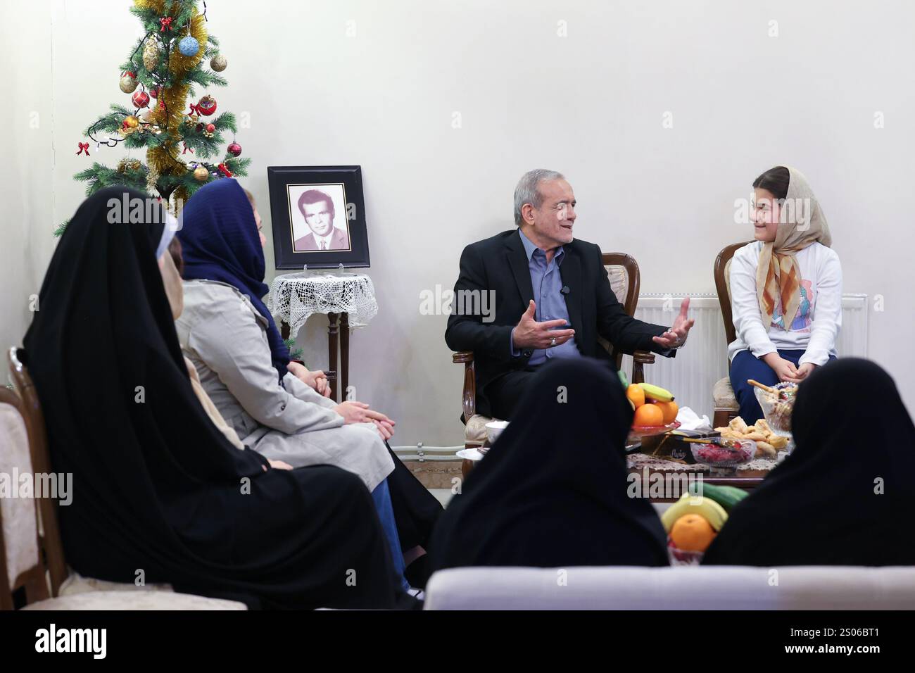 Tehran, Iran. 25th Dec, 2024. Iranian President MASOUD PEZESHKIAN (C ...