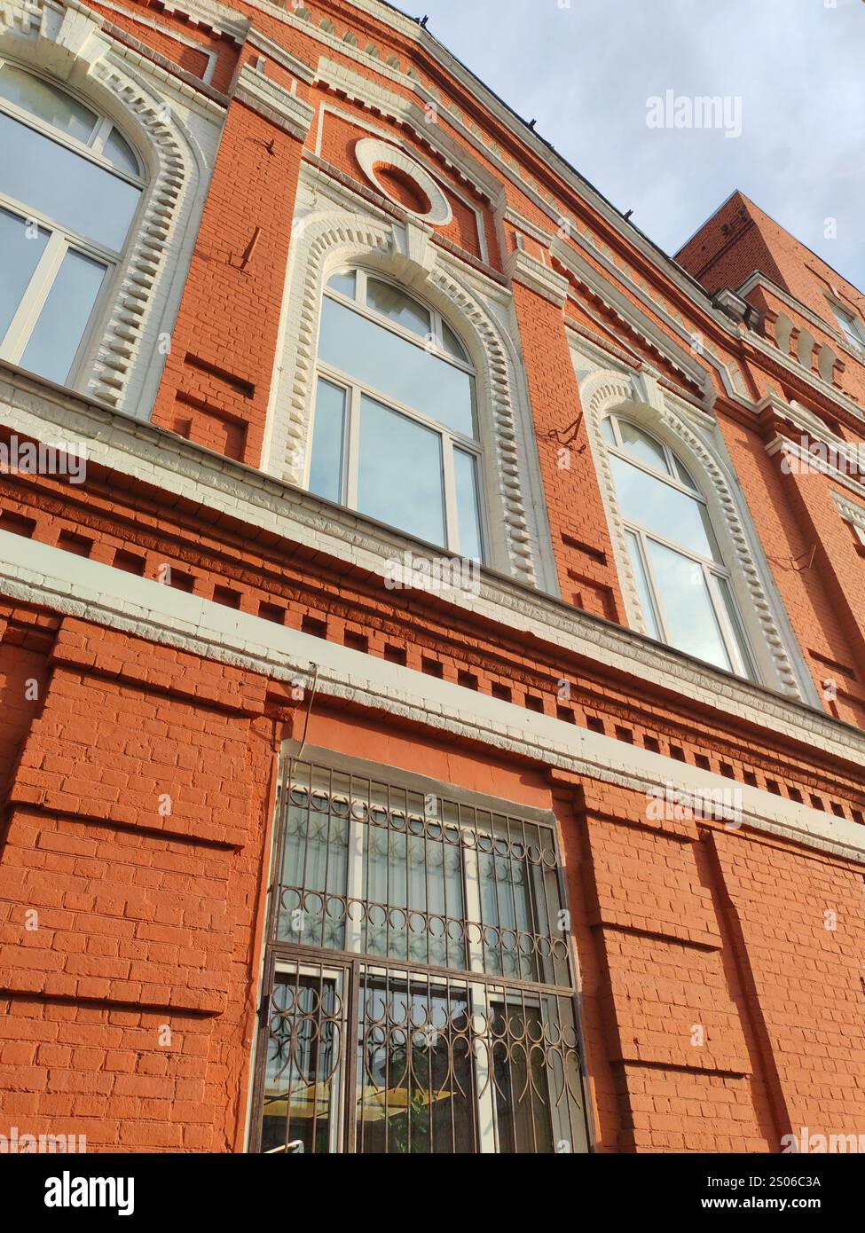 Metal security grilles adorn the windows of a red brick building ...
