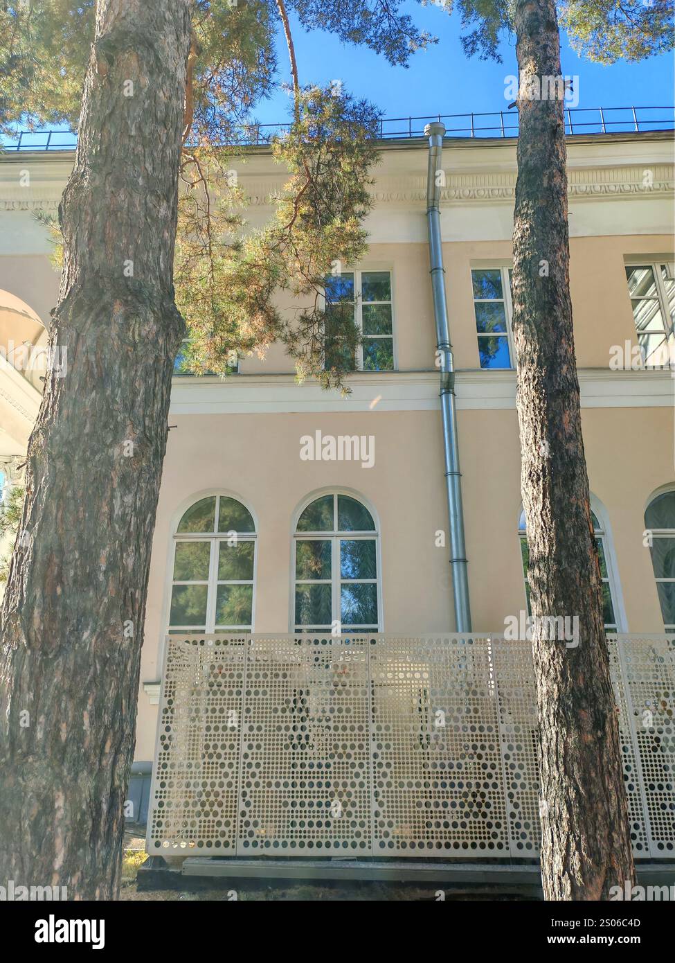 A detailed view of a historic structure featuring elegant windows and a ...