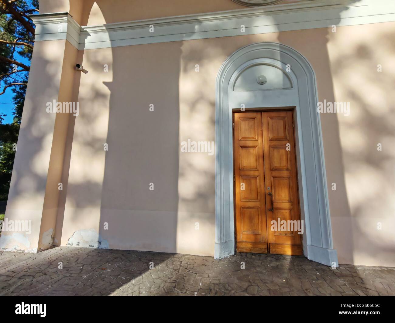 An elegant neoclassical doorway surrounded by light and shadow ...