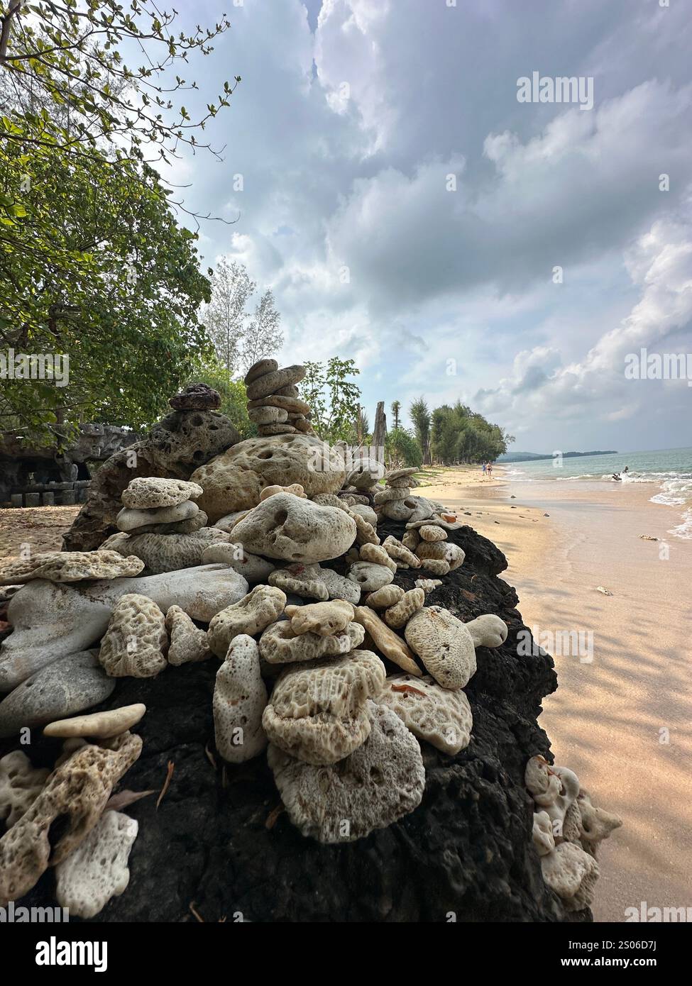 There is a pile of rocks that are positioned on top of another rock ...