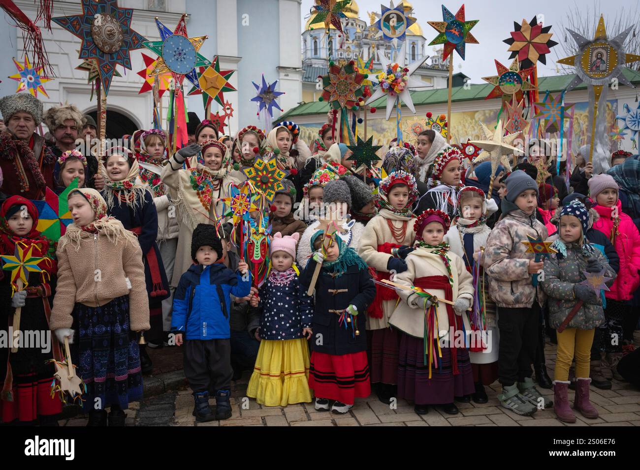 People in national costumes celebrate Christmas near St. Michael ...