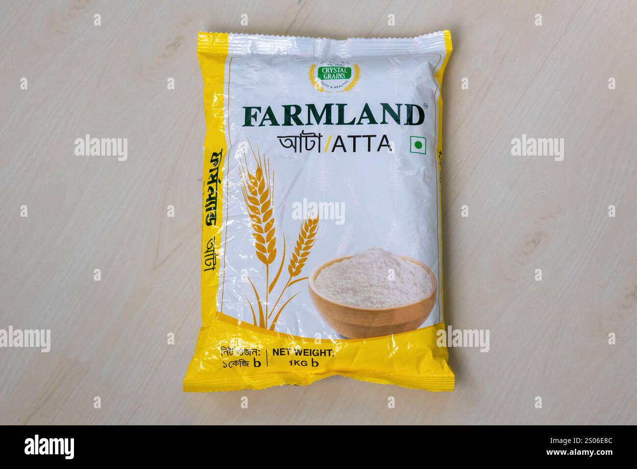 A packet of Farmland Atta wheat flour on a wooden background. Farmland ...