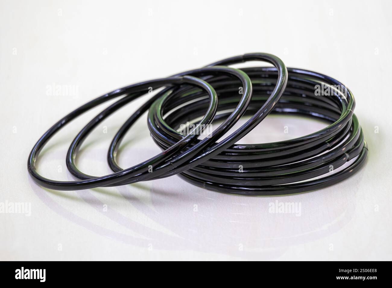 Black glass bangles isolated on a white background Stock Photo - Alamy