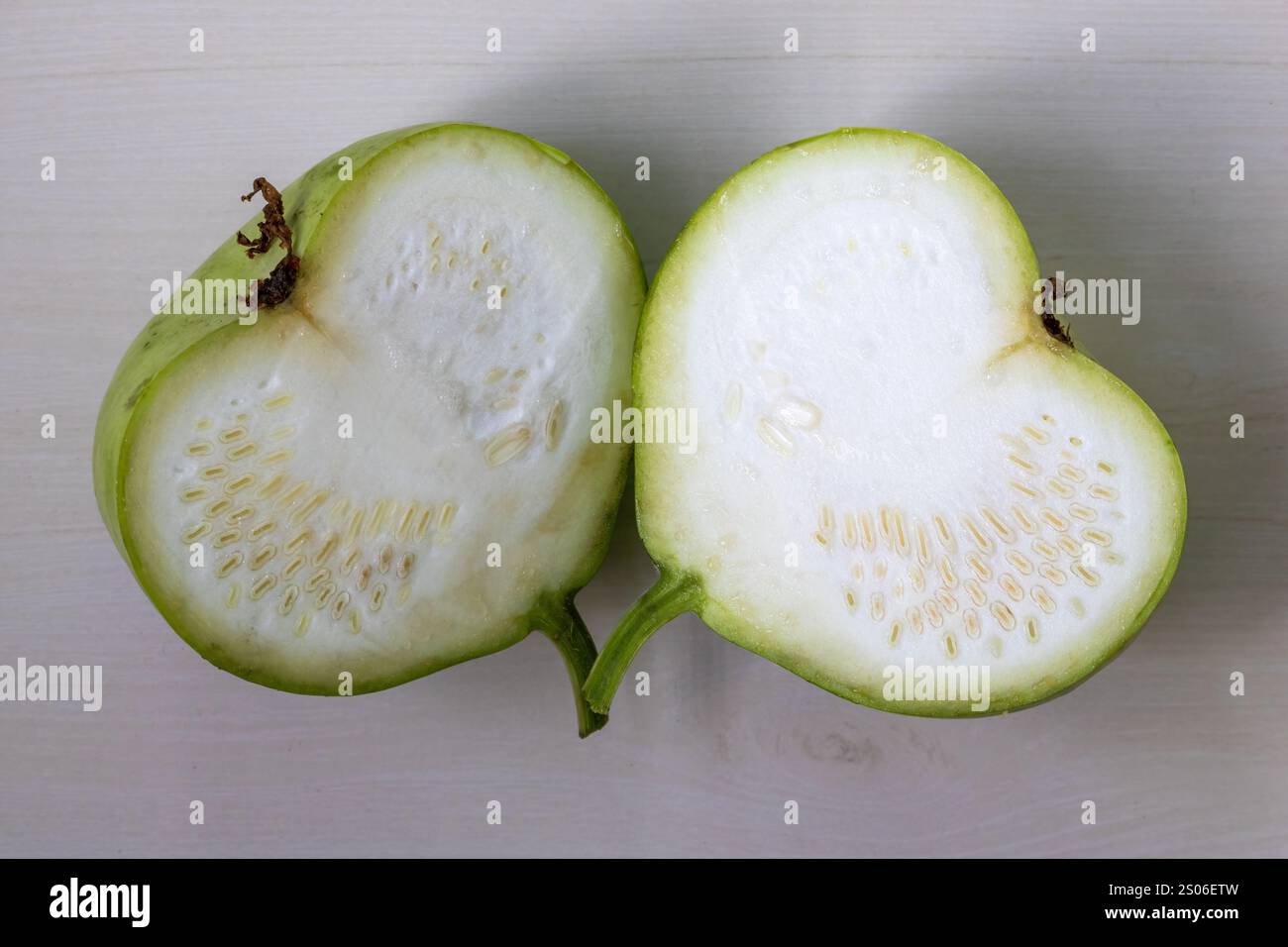 Fresh green round gourd calabash, sliced in half. Top view Stock Photo ...