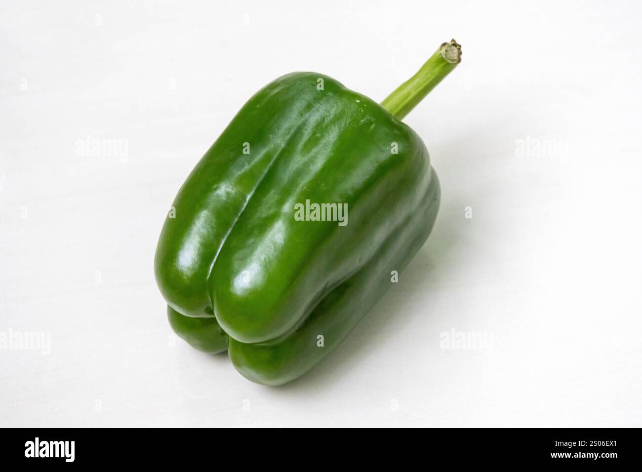 Fresh green bell pepper isolated on white background. It is also known ...