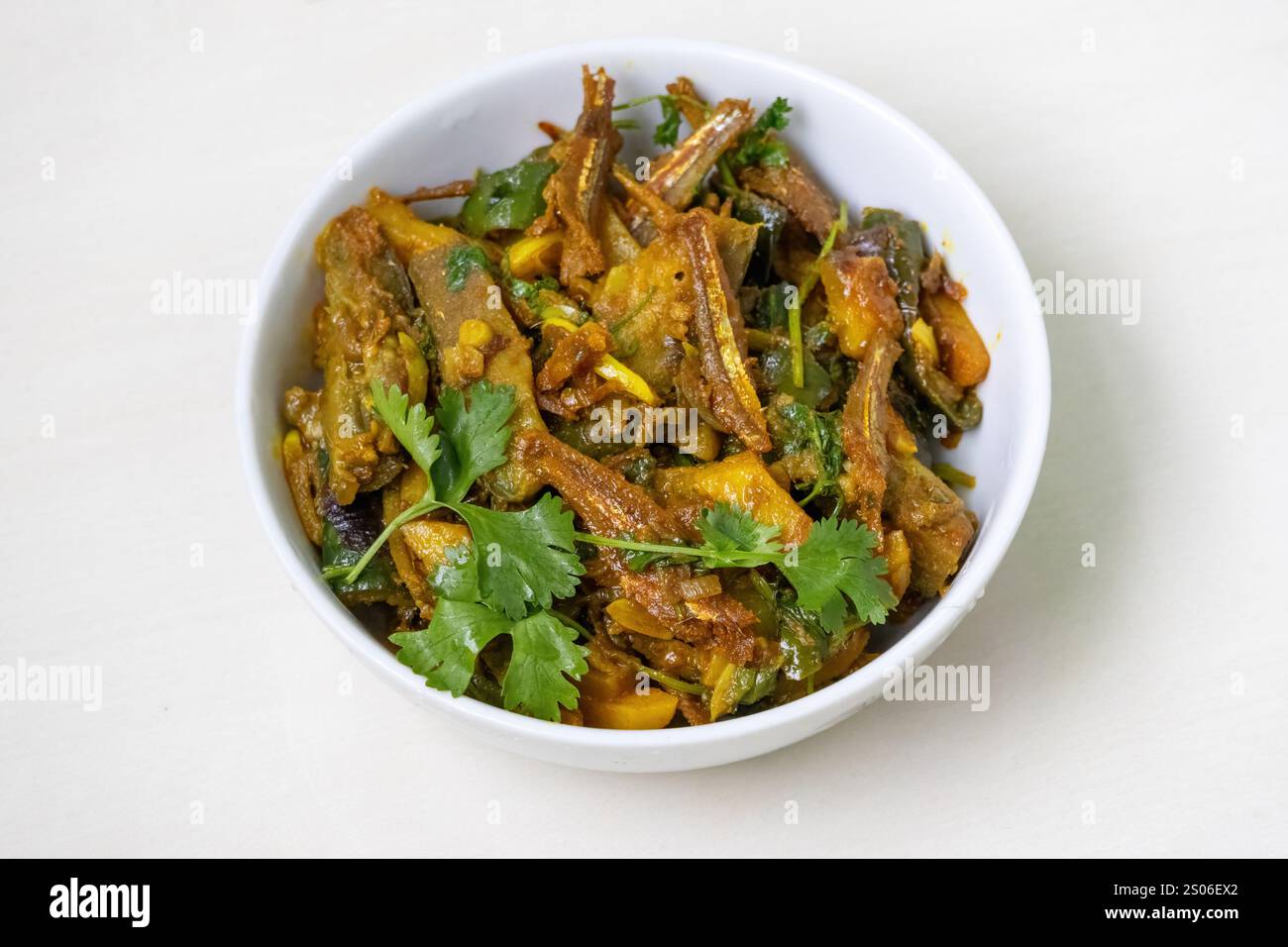 Mola shutki bhuna, a traditional Bengali dry fish curry, served in a ...