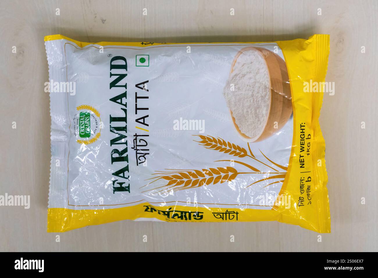 A packet of Farmland Atta wheat flour on a wooden background. Farmland ...