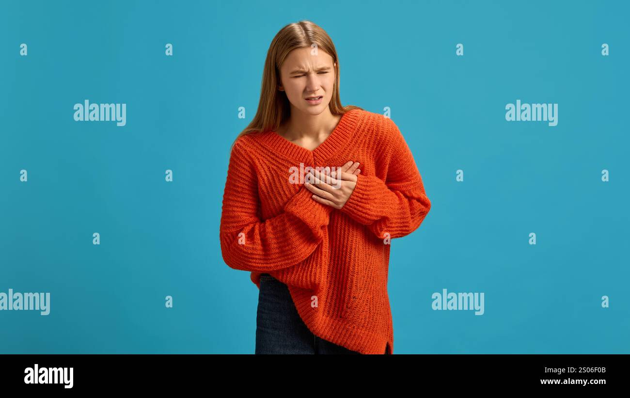 Young girl with hands on chest, feeling a sharp chest pain, heart ...