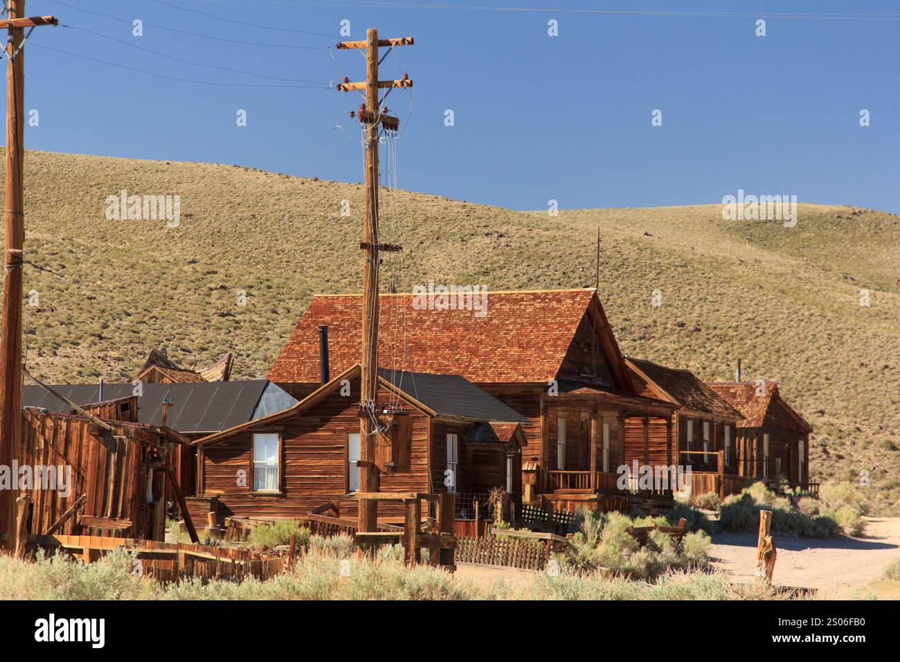 A small, old-fashioned town with a few houses and a few people walking ...