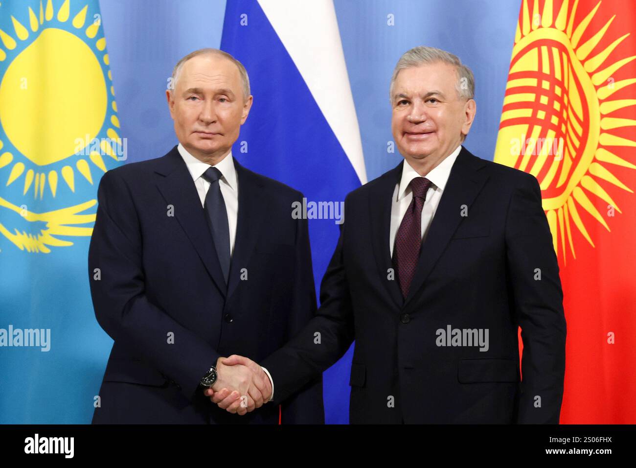 Russian President Vladimir Putin, left, and Uzbek President Shavkat Mirziyoyev pose for a photo ...