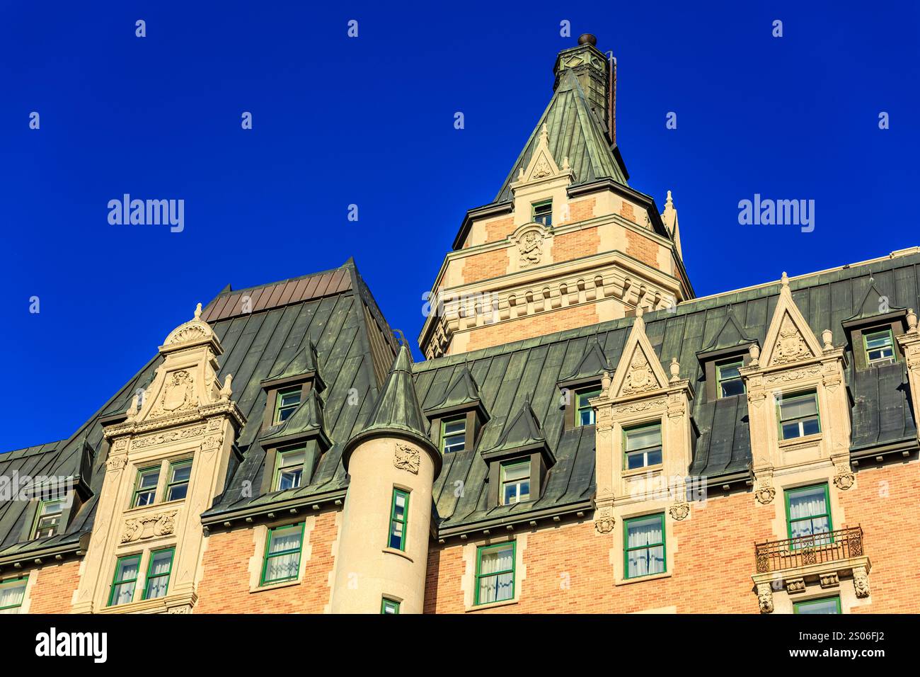 A large building with a green roof and a green spire. The building has ...