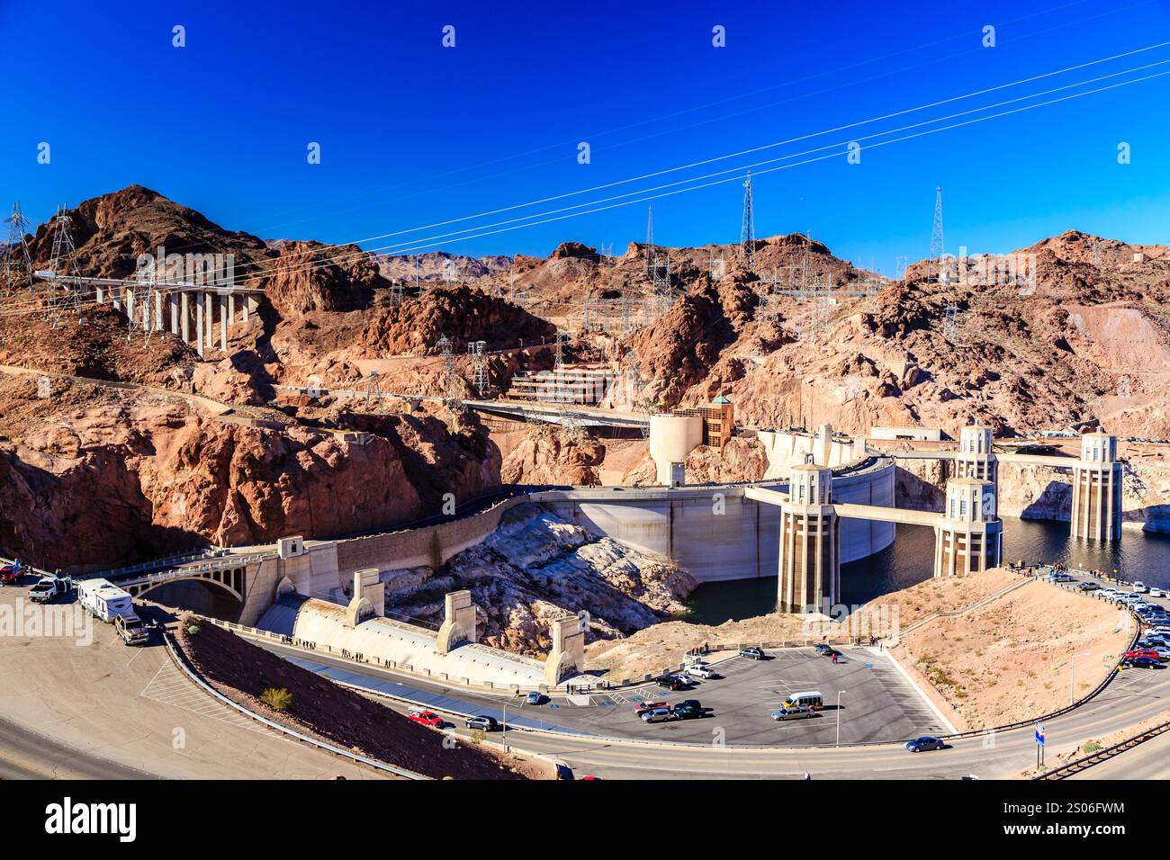 A large dam is built on a mountain. The dam is surrounded by a large ...