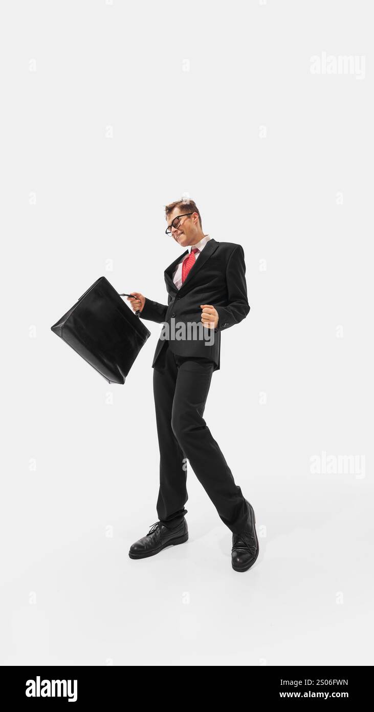Man in sharp black suit and red tie striking exaggerated confident pose ...