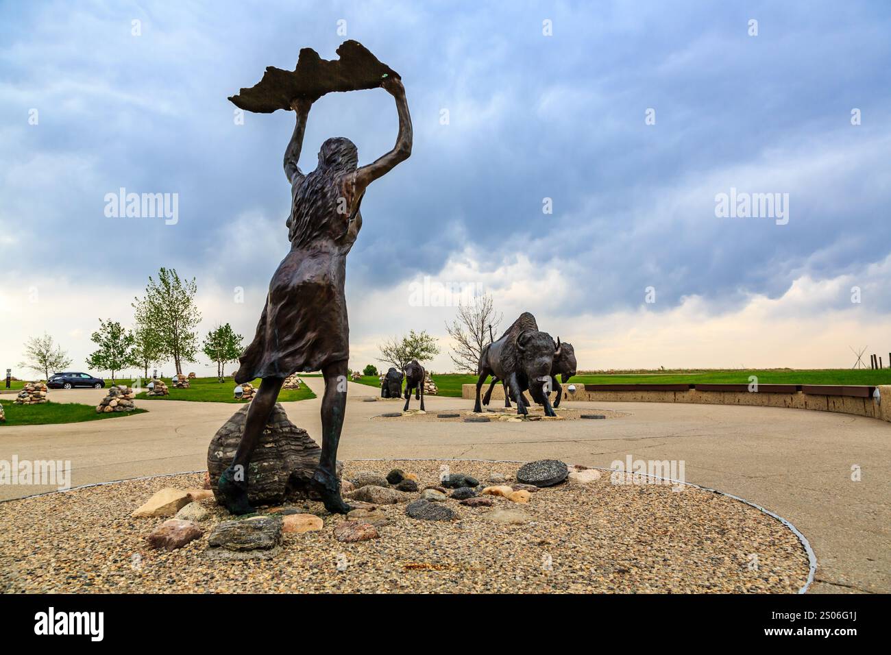 A statue of a woman holding a large rock in her hand. The statue is ...