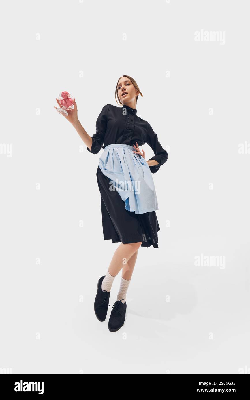 Server with confident smile and serving ice cream poses in professional ...