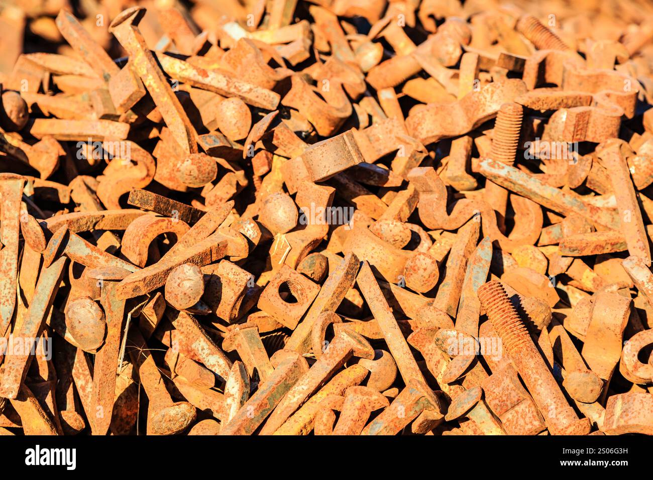 A pile of rusty nails and screws. The pile is made up of many different ...