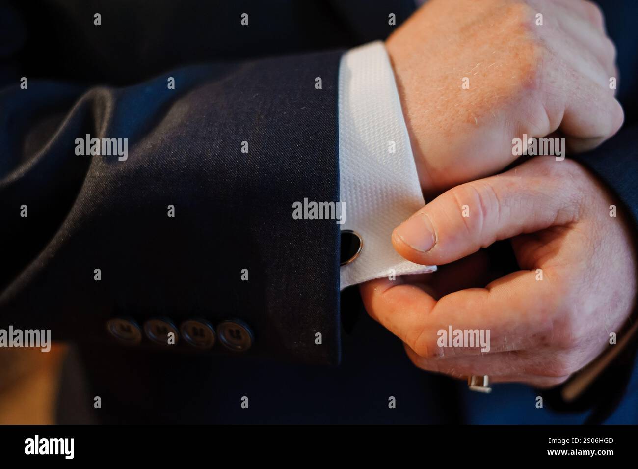Elegant Groom Adjusting Cufflink on Formal Suit Stock Photo - Alamy