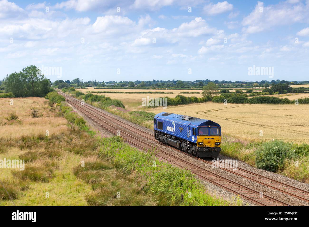 DB Cargo Rail (UK) Maritime livery class 66 diesel locomotive passing ...