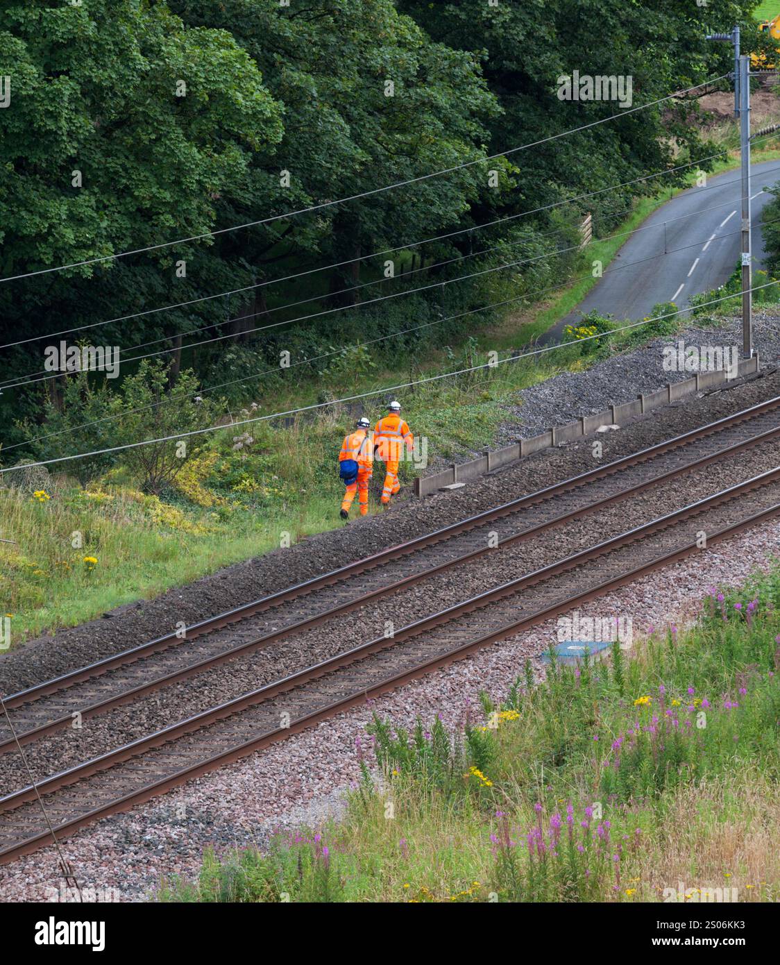 Network Rail workers walking alongside the west coast mainline to get ...