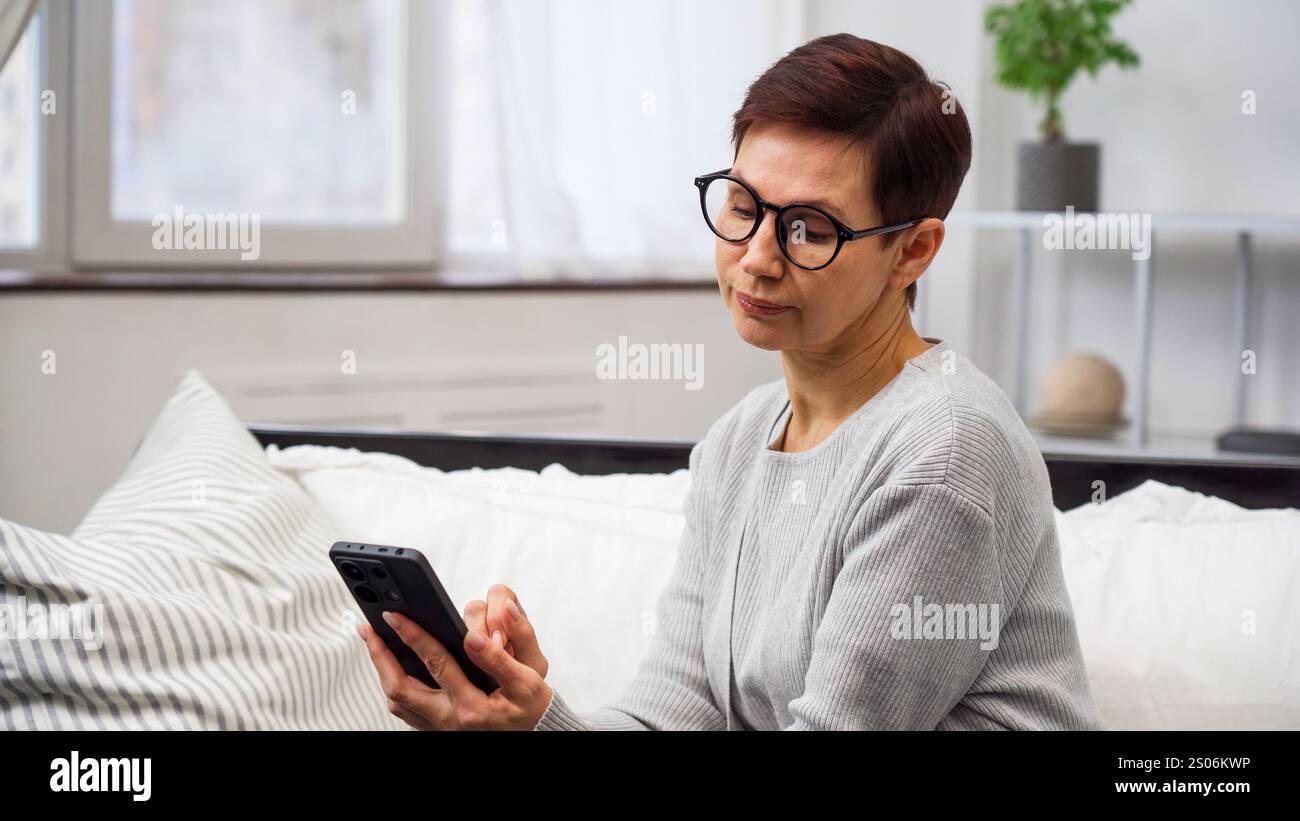 Woman scrolling through phone hi-res stock photography and images - Alamy