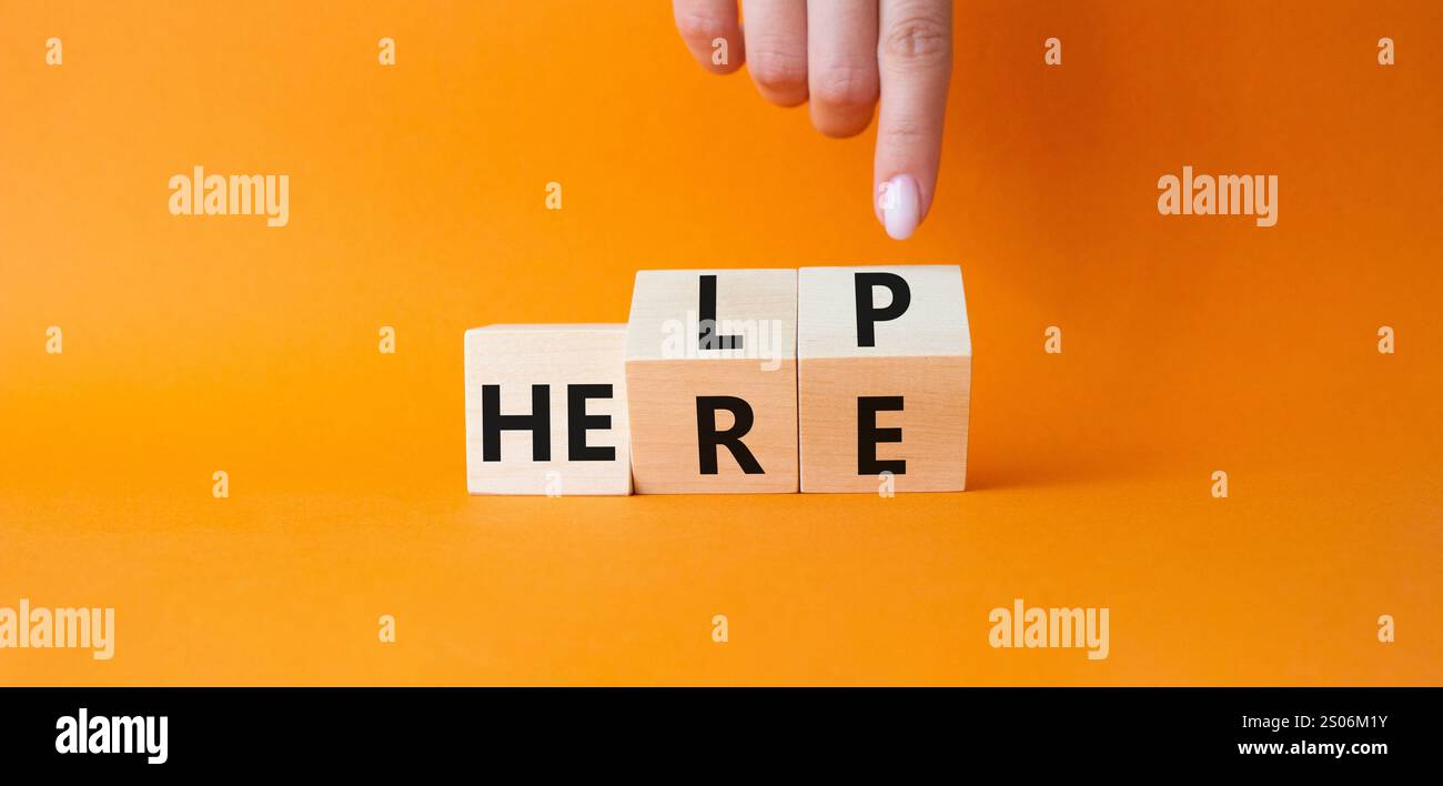 Help is here symbol. Businessman hand points at cube with words Here to ...