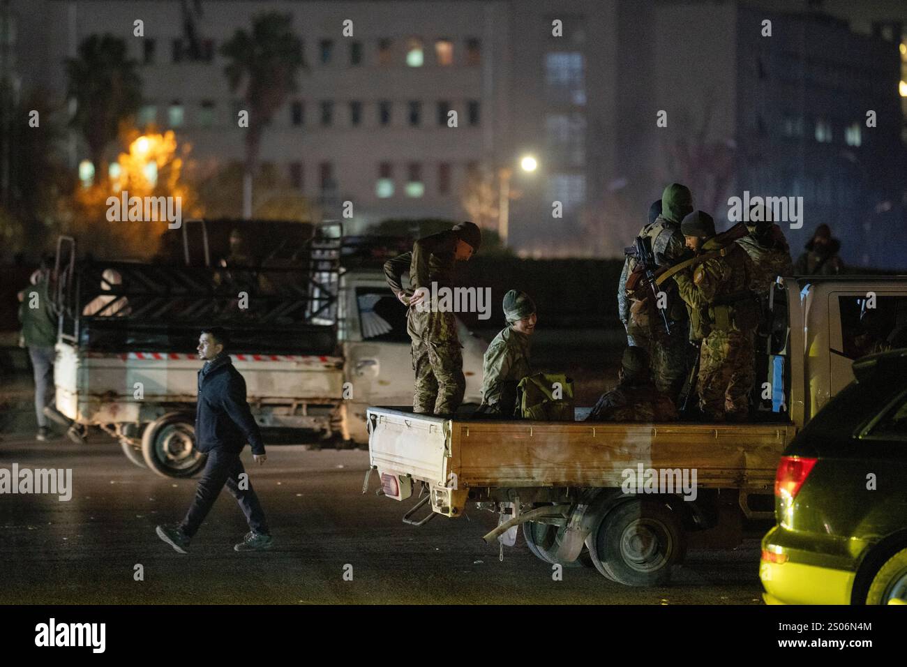 Syrian fighters stand on vehicle parked on a street at the central ...