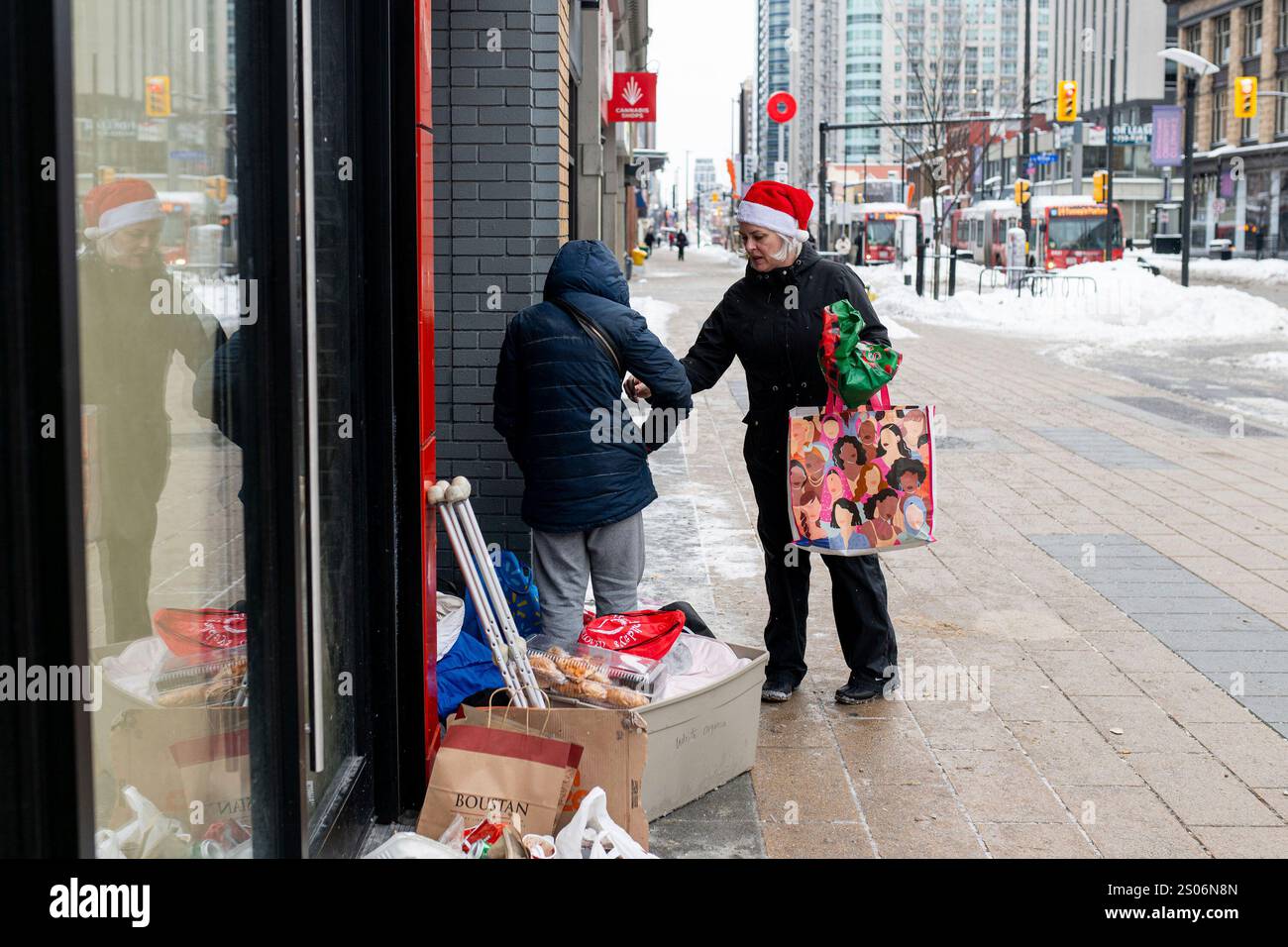 Shawna Thibodeau, right, of Shawna's Outreach hands a gift card to a ...