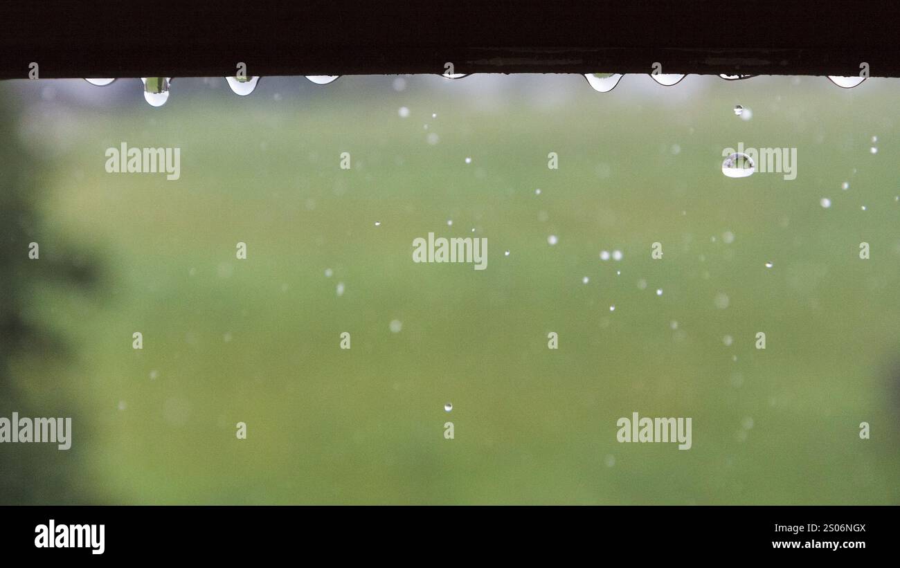 Raindrops hanging on the window frame, window pane, symbol photo, rainy summer, rainy weather ...