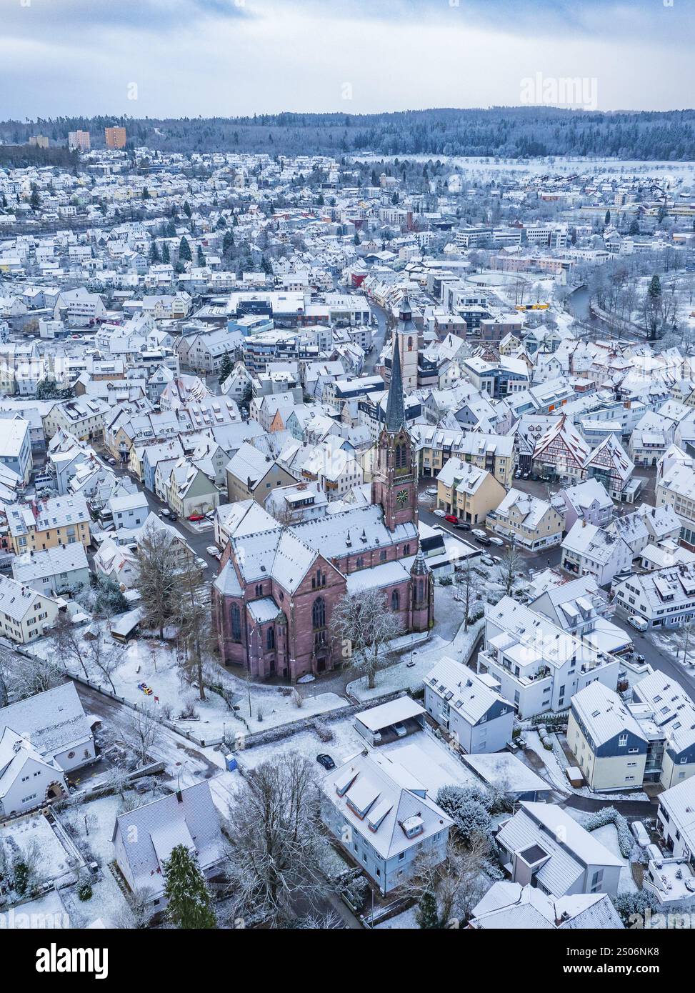 Aerial view of a wintry town with central church and snow-covered ...