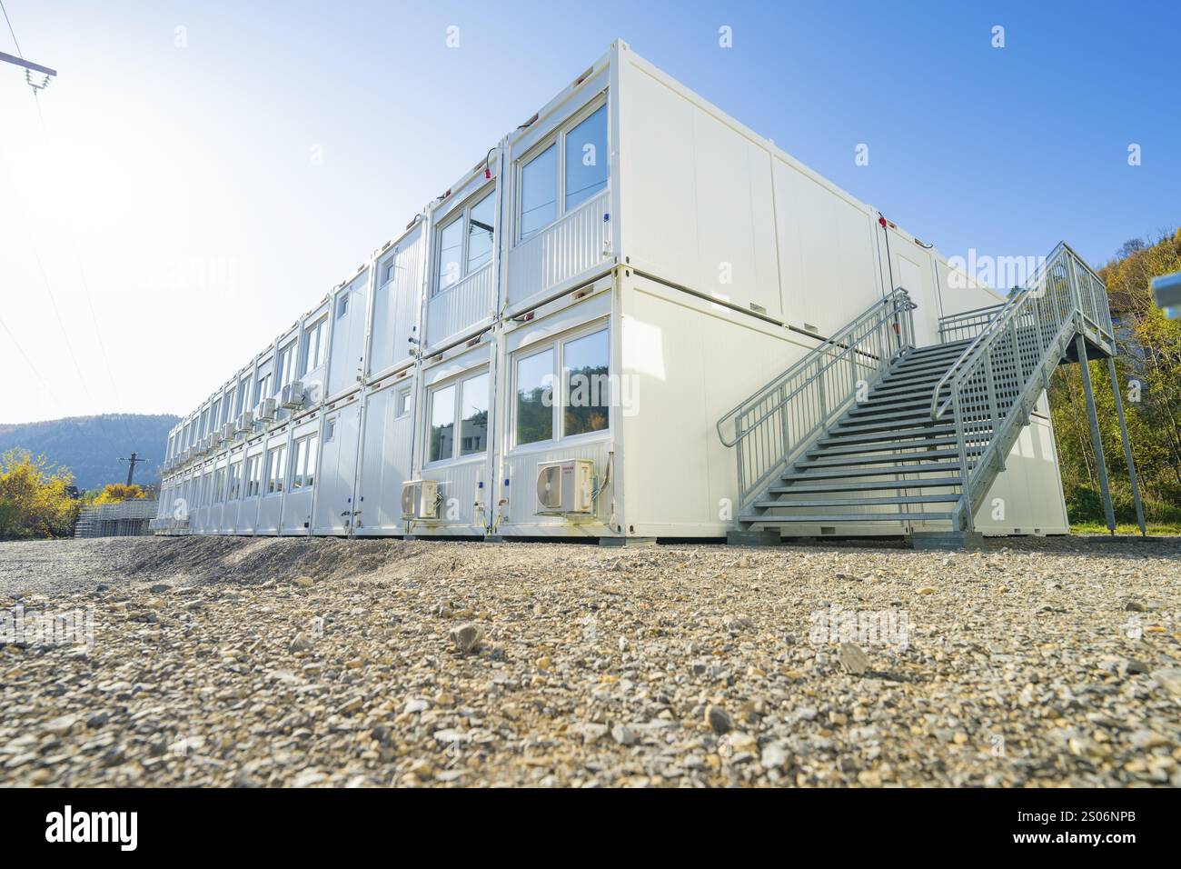 Container building with stairs, graphic lines in front of blue sky and ...