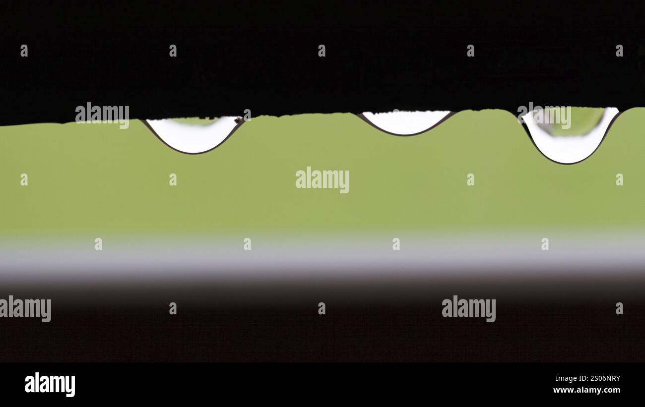 Three raindrops hanging on the window frame, close-up, symbol photo ...