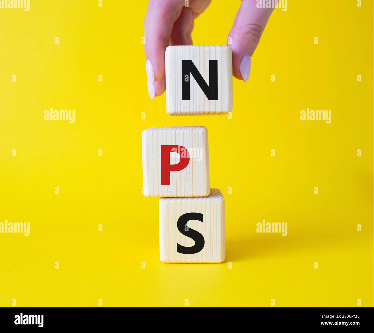 NPS - Net Promoter Score symbol. Wooden cubes with words NPS ...