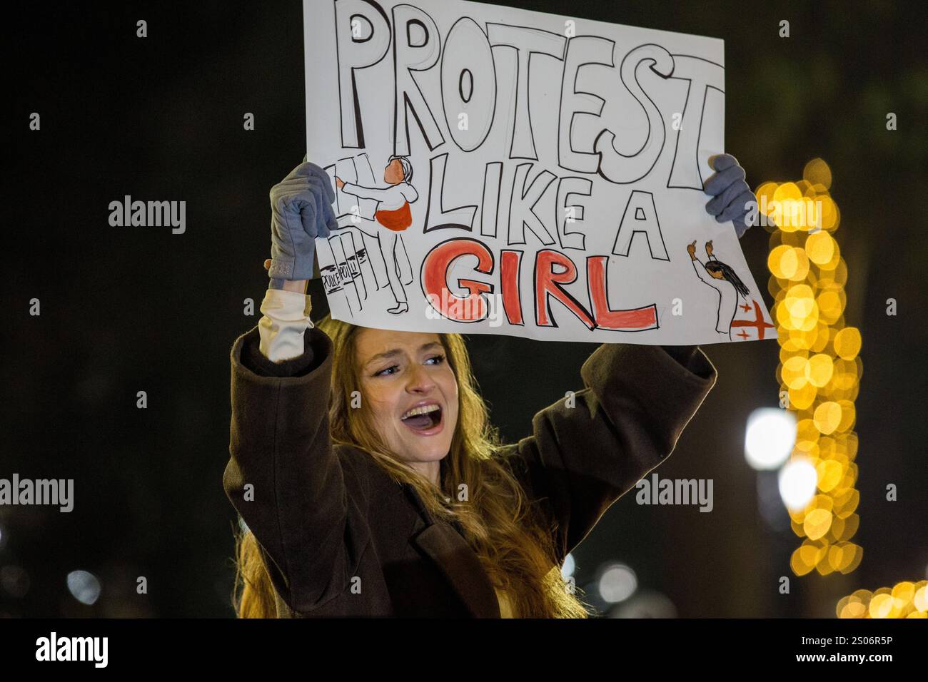 A woman holds a placard during a protest against the suspension of the ...