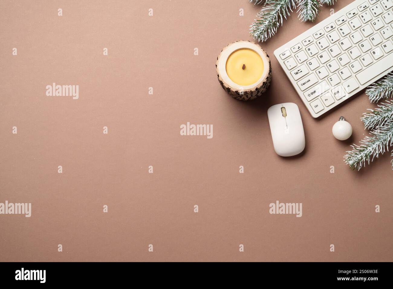 Cozy Winter office desk. Keyboard, candle and winter decor at brown ...