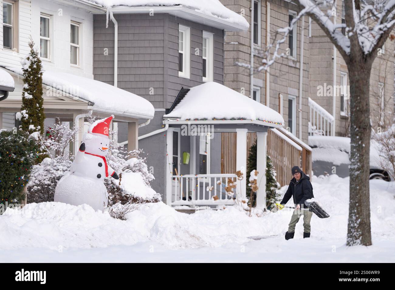 A person shovels snow following a winter storm in Halifax on Christmas ...