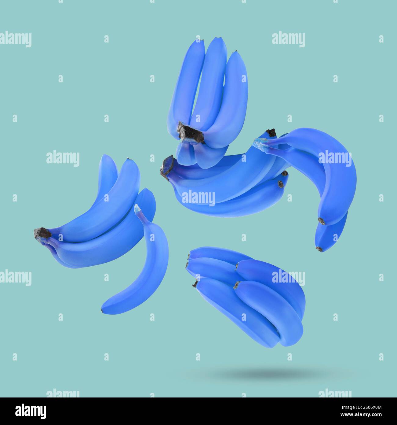 Blue violet bananas in air on color background Stock Photo - Alamy