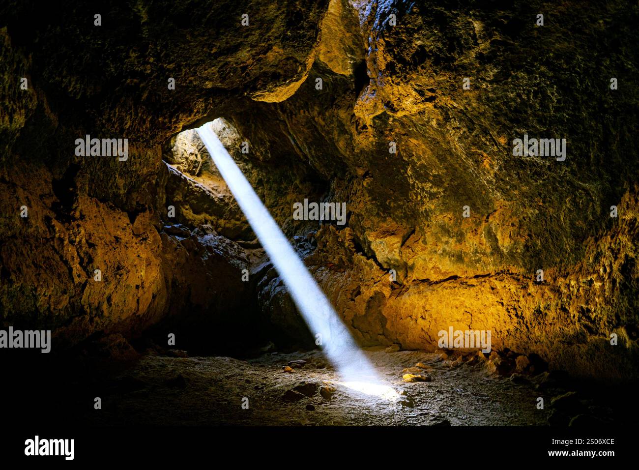 A single beam of light pierces through the darkness of the Lava Tubes ...