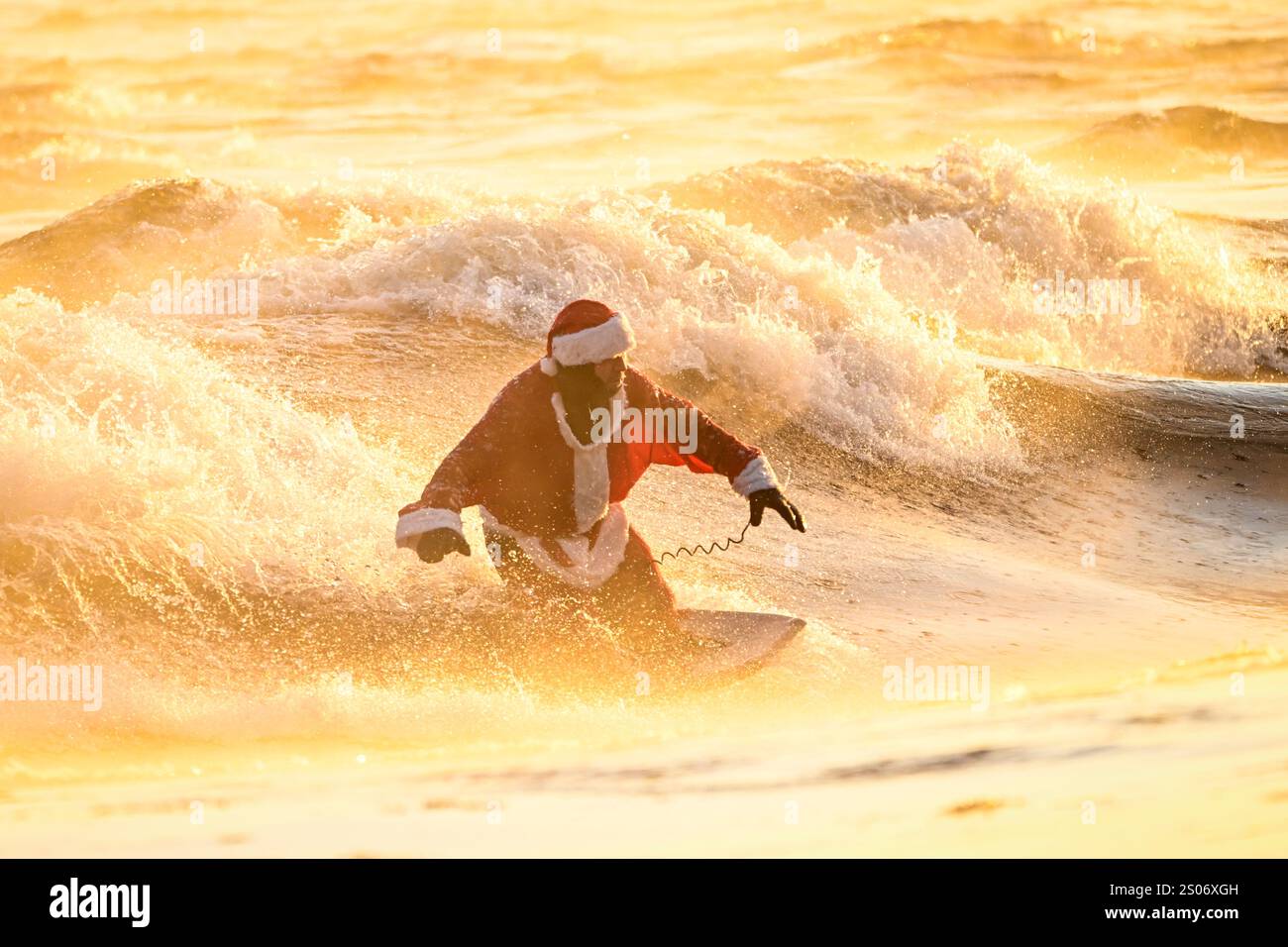 Carlos Hebert Plante, who boogie boards daily, dressed as Santa Claus ...