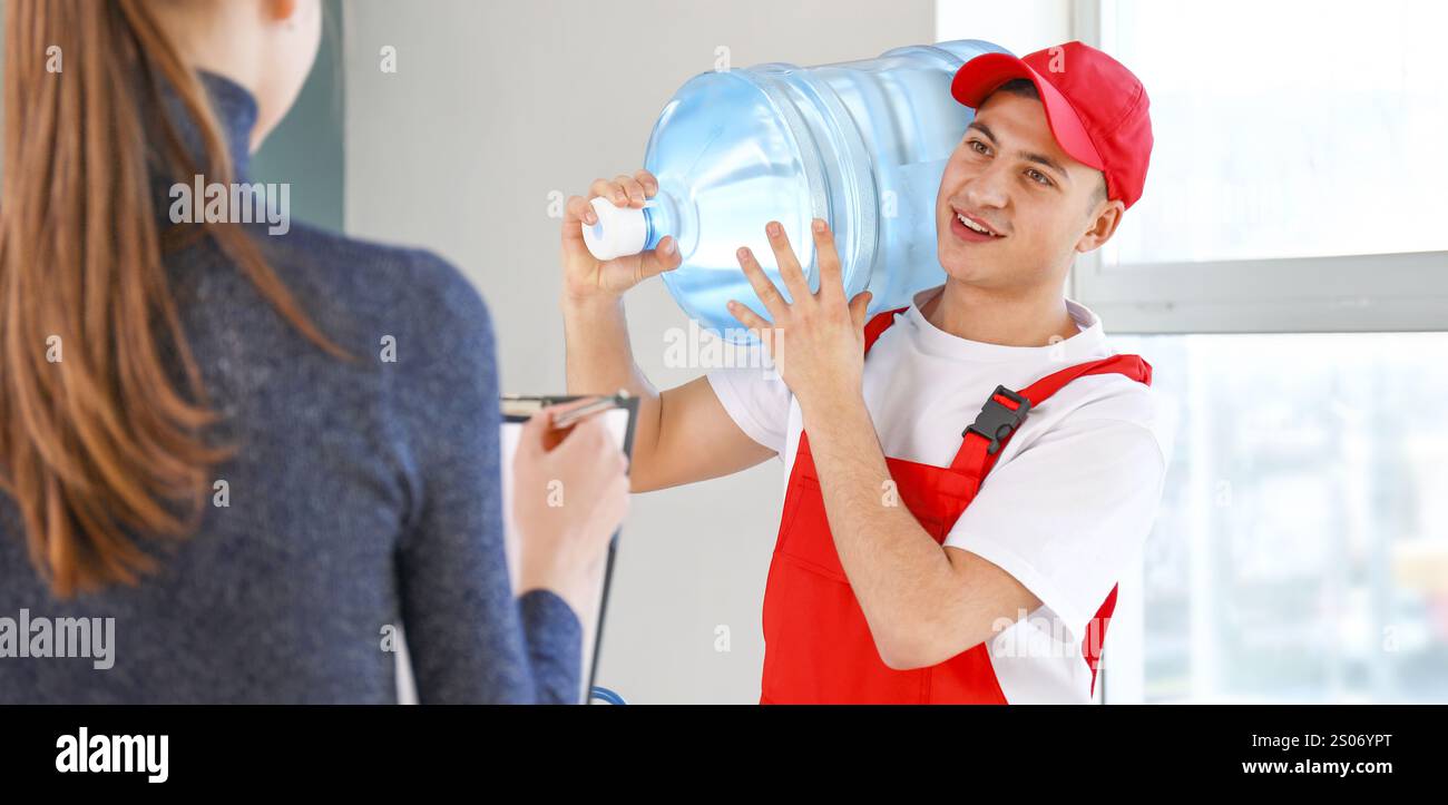 Male courier delivering bottle of water to customer Stock Photo - Alamy