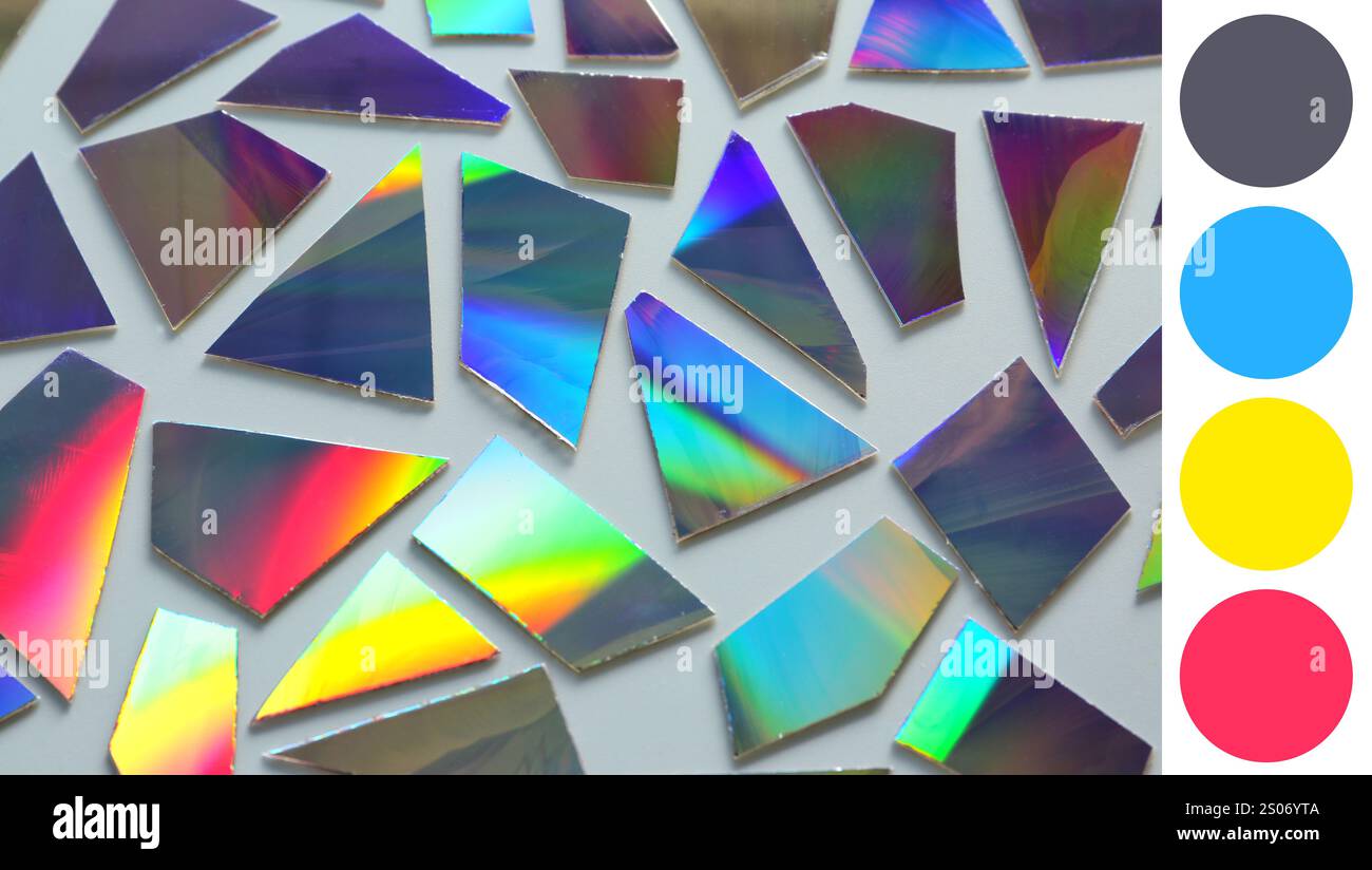 Shiny iridescent pieces of CD disk on white background. Different color ...