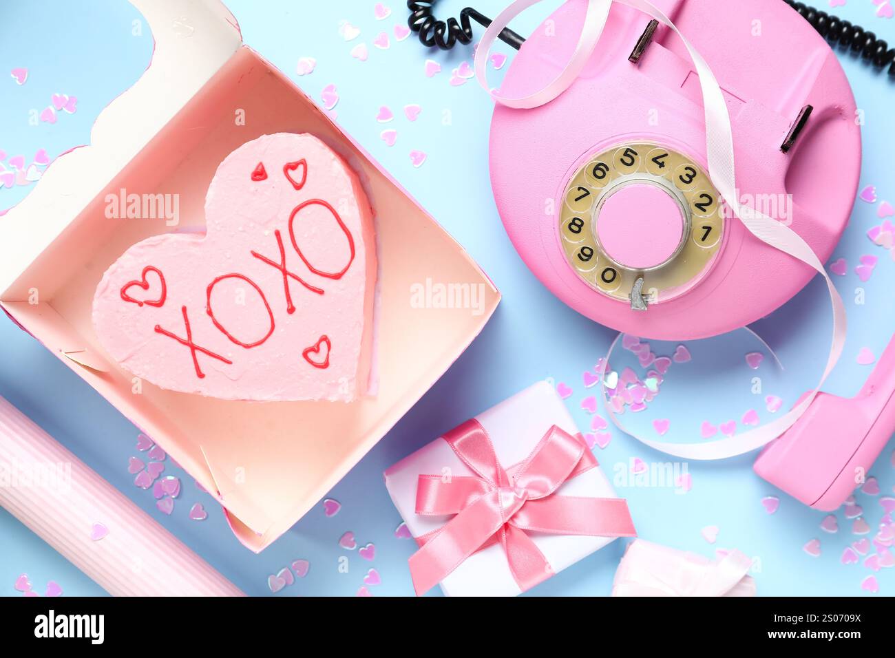 Heart-shaped bento cake with gift boxes and retro phone on blue ...
