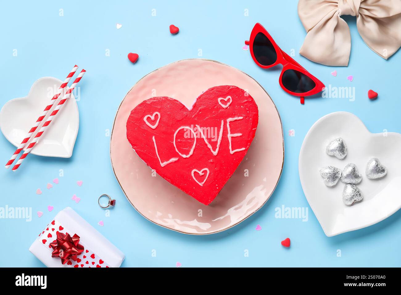 Heart-shaped bento cake with gift box, chocolate candies and ring on ...