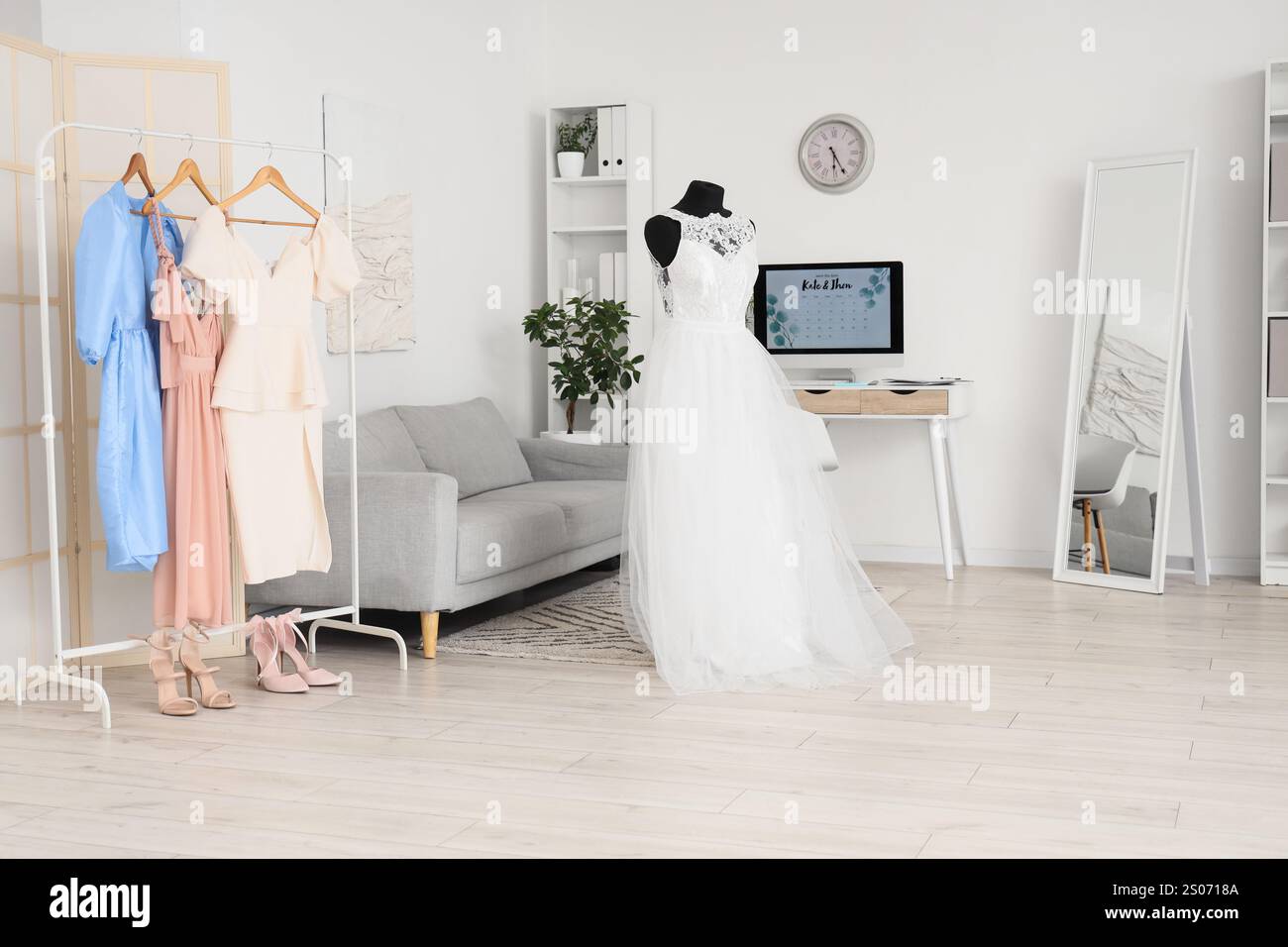 Interior of wedding planner's office with workplace, clothes and sofa ...