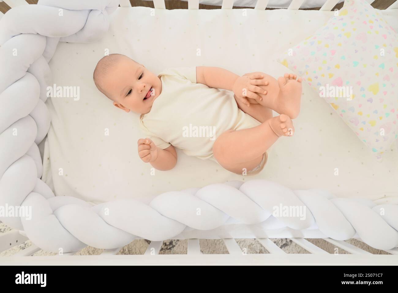 Cute little baby lying in crib, top view Stock Photo - Alamy