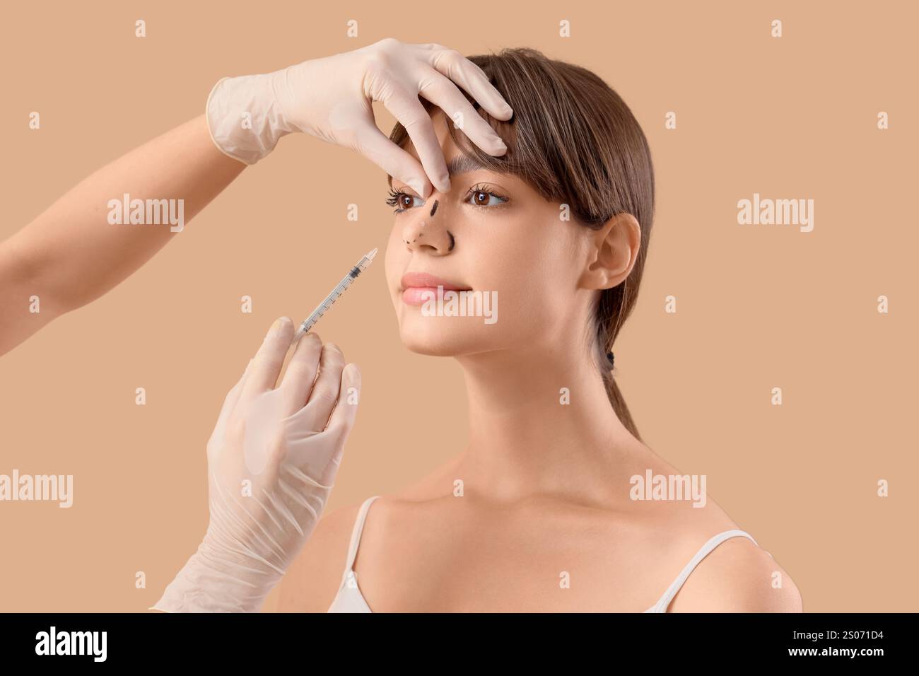 Young happy woman receiving plastic surgery injection on beige ...
