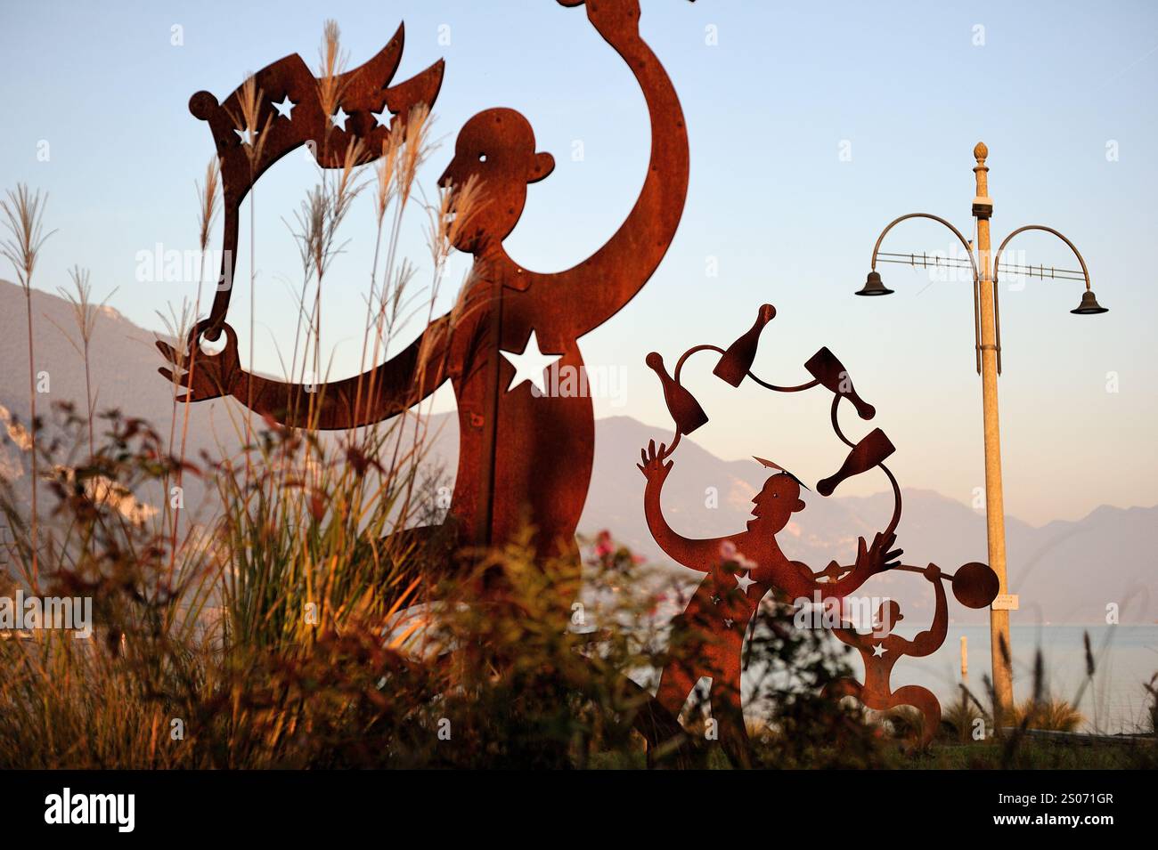 Circus people playing made in sheet metal silhouettes Stock Photo - Alamy